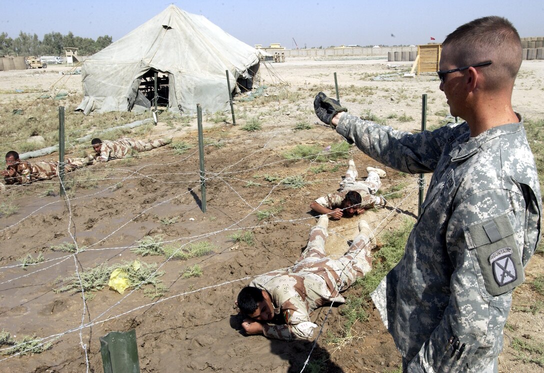 U.S. Army Staff Sgt. Charles Bruckner instructs Iraqi army soldiers as ...