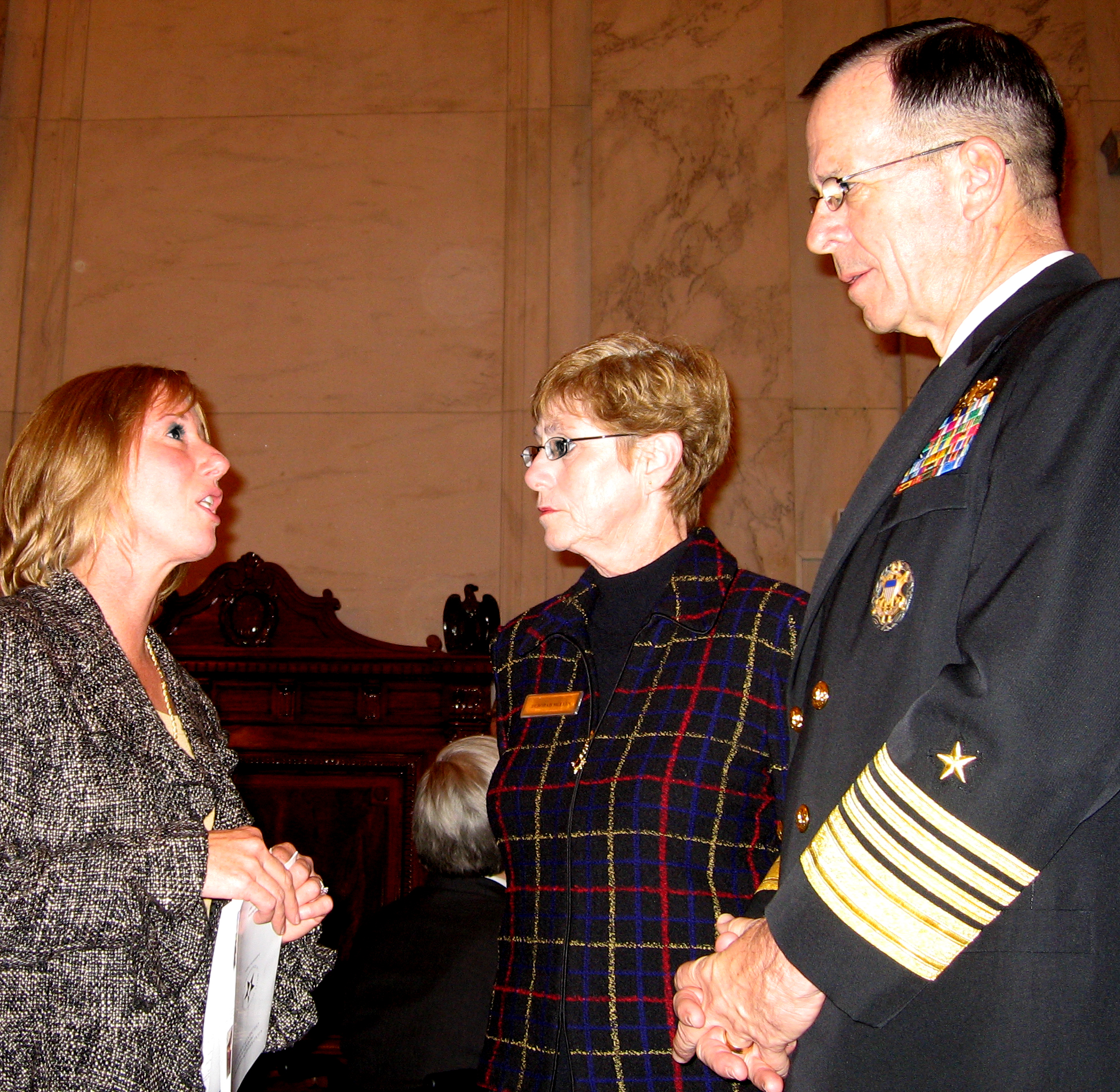 Beth Downs, left, talks with Deborah Mullen and her husband, Chairman ...