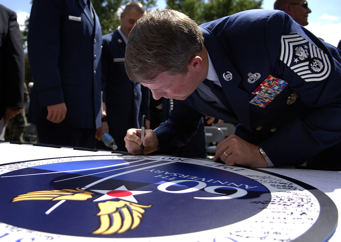 Chief Master Sgt. of the Air Force Rodney J. McKinley signs a ...