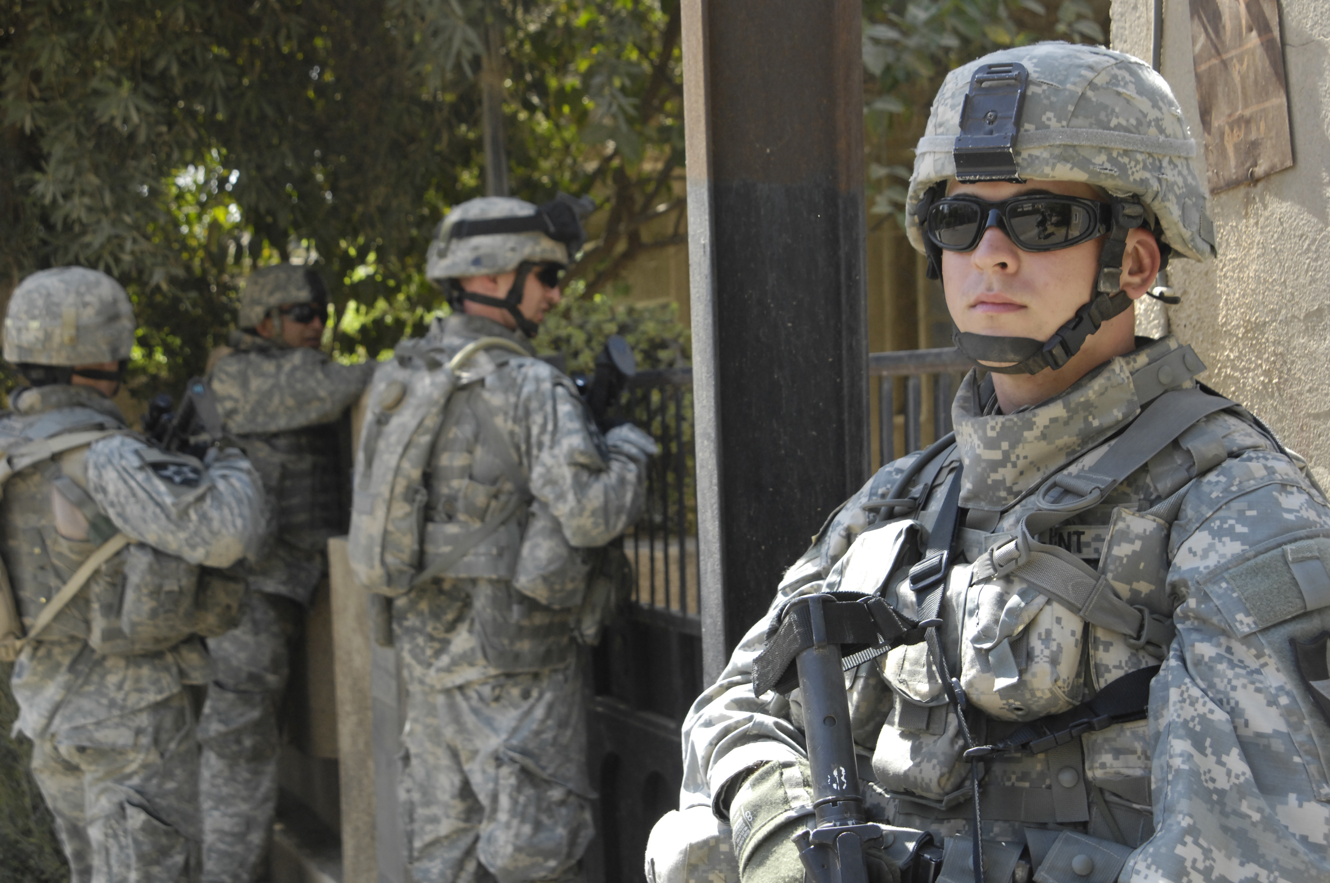 U.S. Army Pvt. Joseph M. Dement, right, guards his position in the city ...
