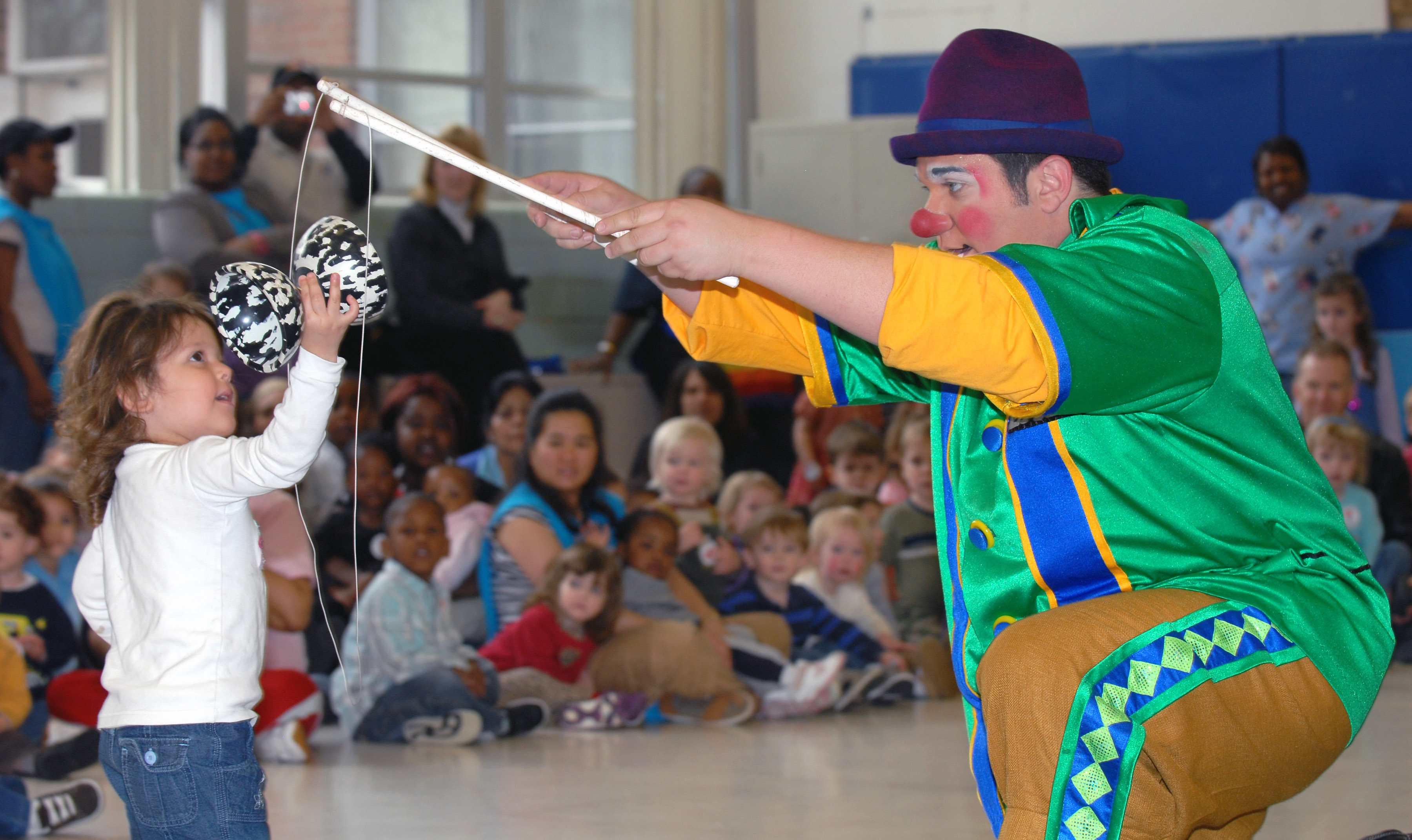 Natalie Steinbach, 3, returns a prop to Larry the clown after it rolled ...