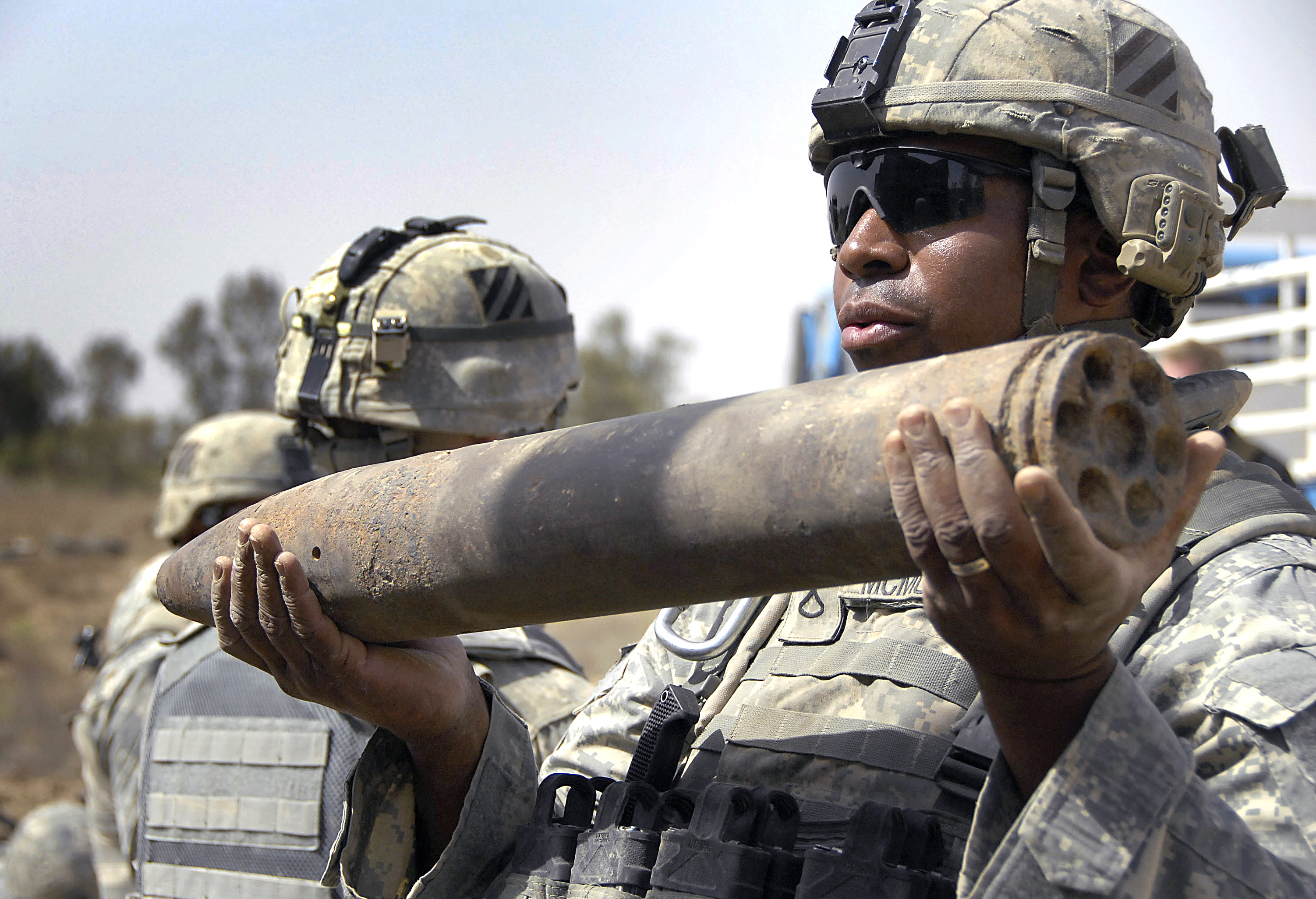 U.S. Army Soldiers load ordnance from a weapons cache onto a trailer ...