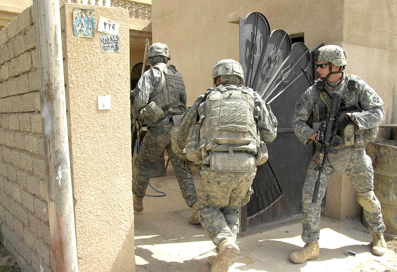 U.S. Army soldiers clear a building while performing a cordon and ...