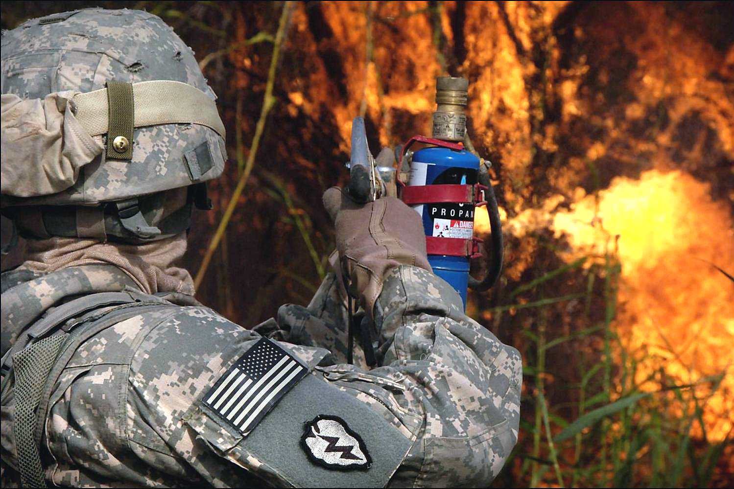 A U.S. Army soldier copes with the overwhelming heat that comes with ...