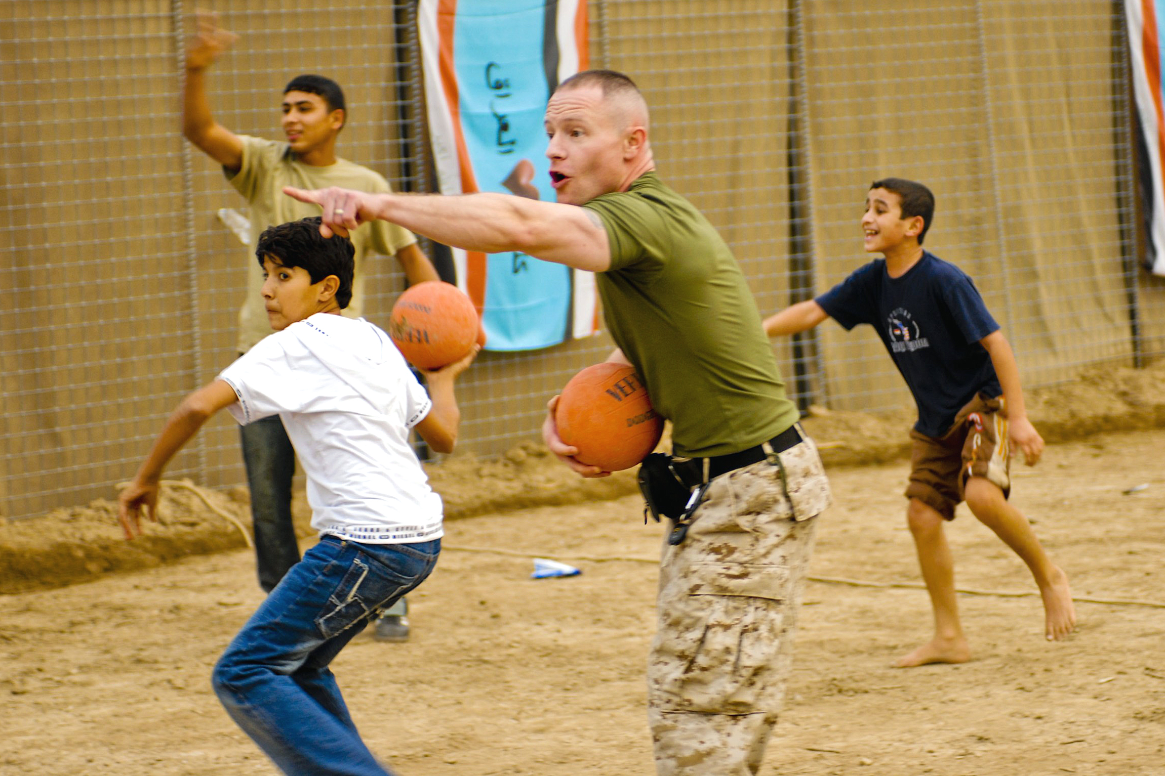 U.S. Marine Corps Gunnery Sgt. Kevin Weintraub points to a boy who was ...