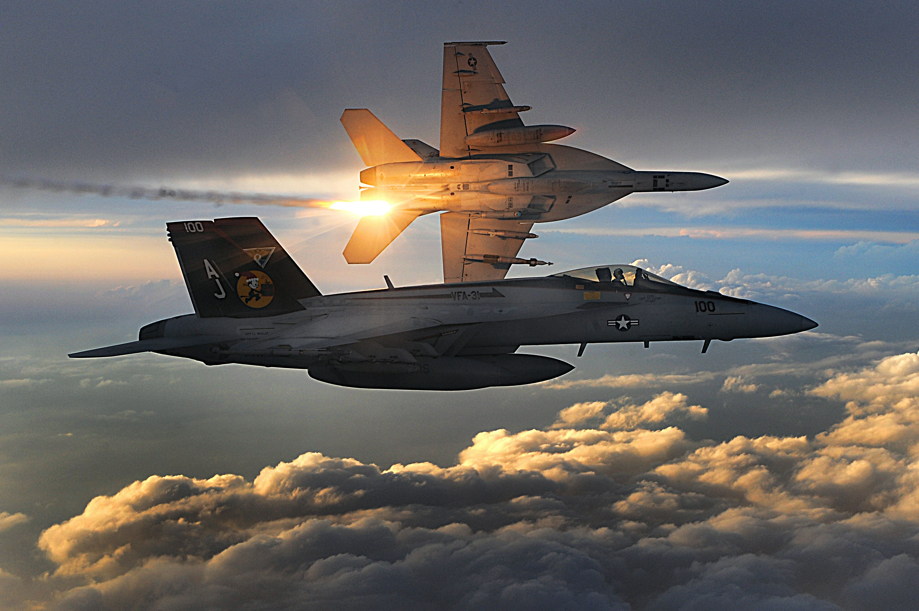 U.S. Navy F/A-18 Super Hornets deploy heat flares during a combat ...