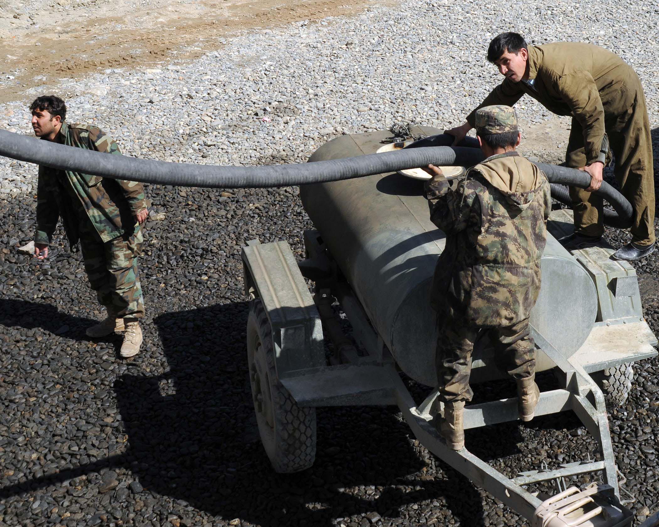 Afghan National Army soldiers pump fuel at a depot in Kabul ...