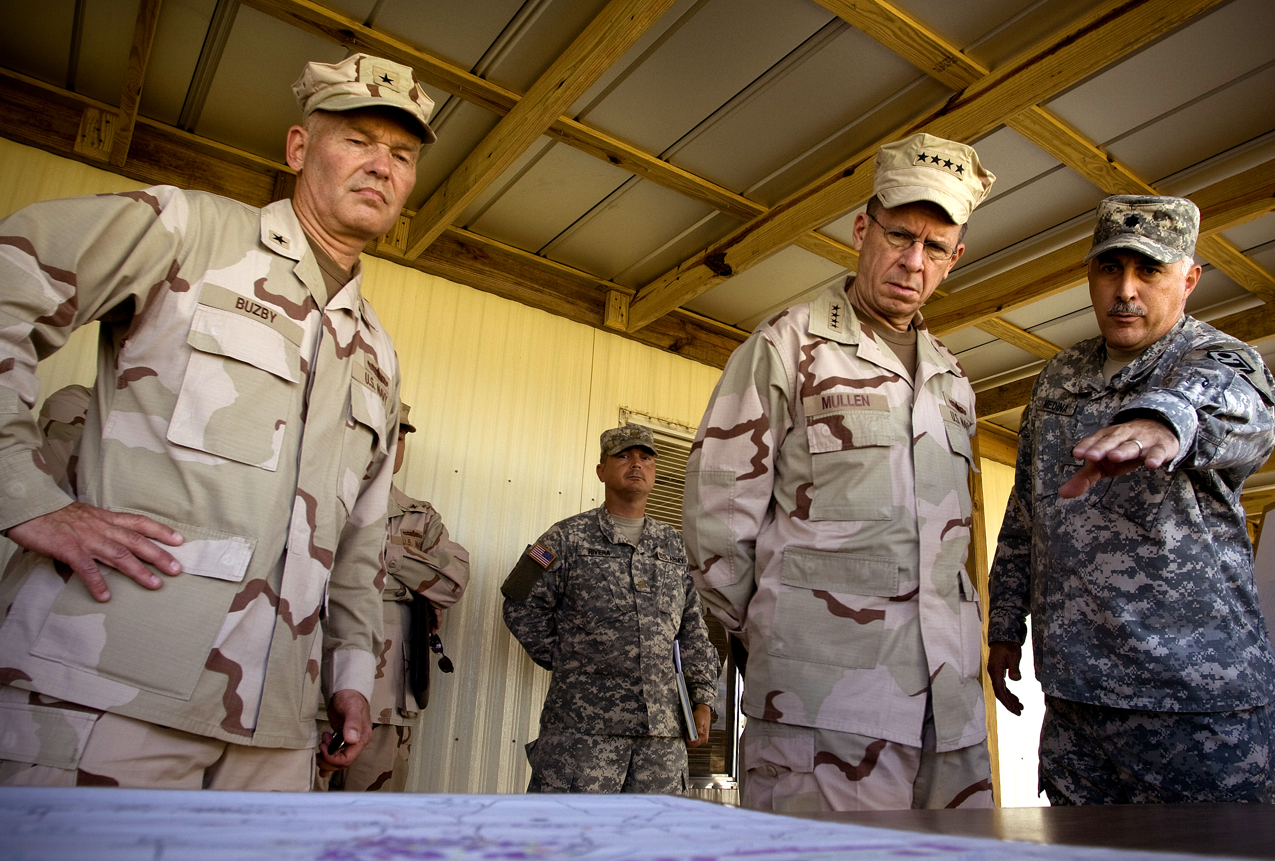 U.S. Navy Adm. Michael G. Mullen, chairman of the Joint Chiefs of Staff, receives a brief from ...