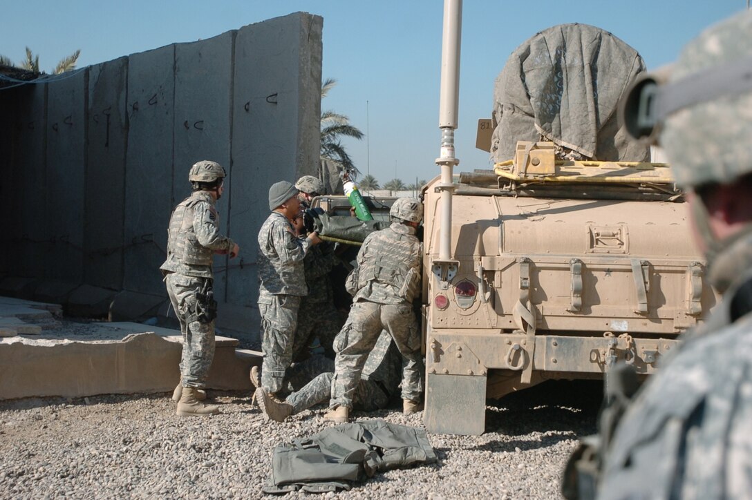 Medics at Patrol Base Murray, Iraq, load Mohammed Ali Abas into a Humvee to transport him to ...