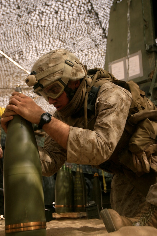 U.S. Marine Lance Cpl. David R. Wyble sets a time fuse on a 155mm ...