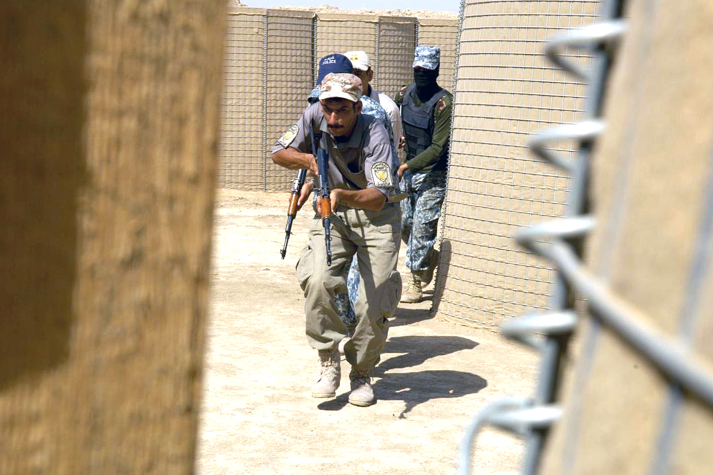 Iraqi SWAT team police officers duck for cover during close-quarter ...