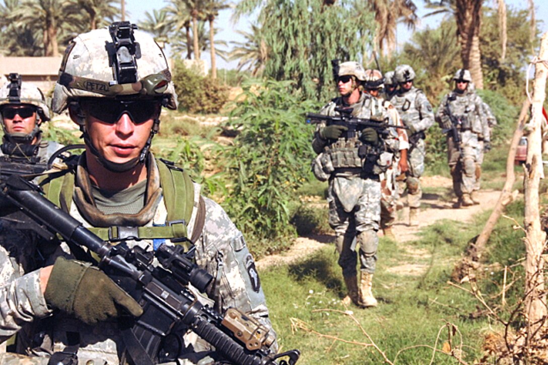 U.S. Army Sgt. Micah Smith walks with his fellow soldiers to the next ...