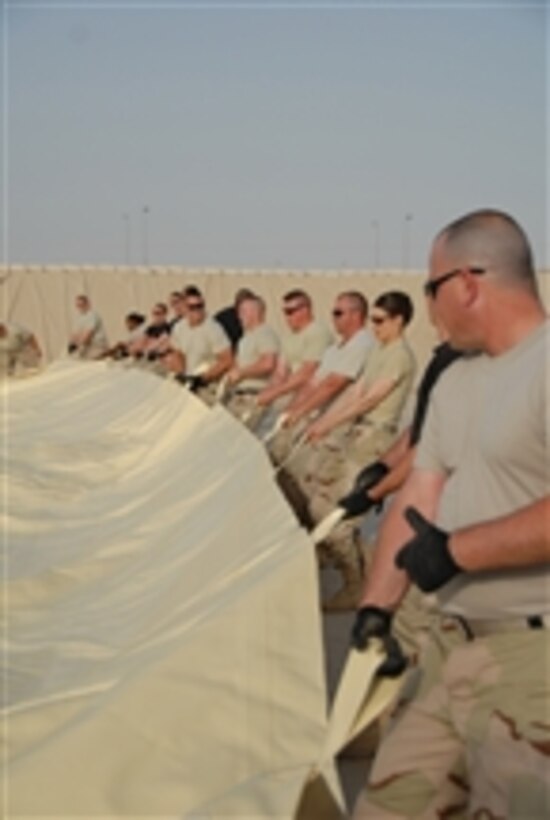 U.S. Air Force airmen spread out a new fuel bladder.