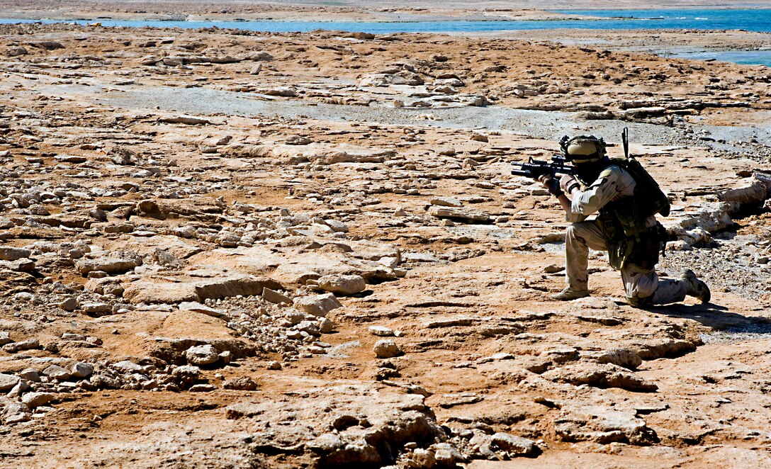 U.S. Navy Senior Chief Petty Officer Patrick Kelly provides security ...
