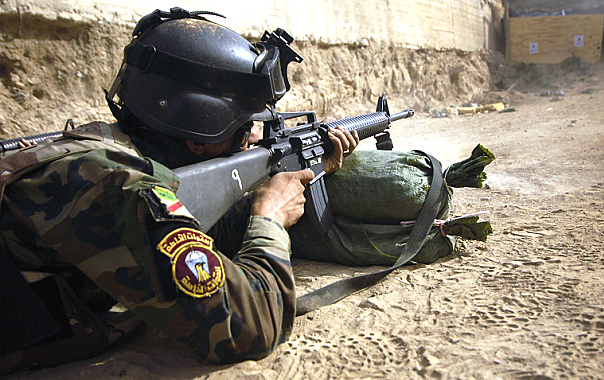 An Iraqi army soldier fires his weapon at targets during weapons ...