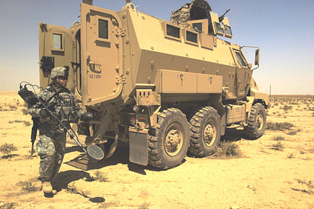 U.S. Army Sgt. Chad Charles dismounts from a mine resistant artillery ...