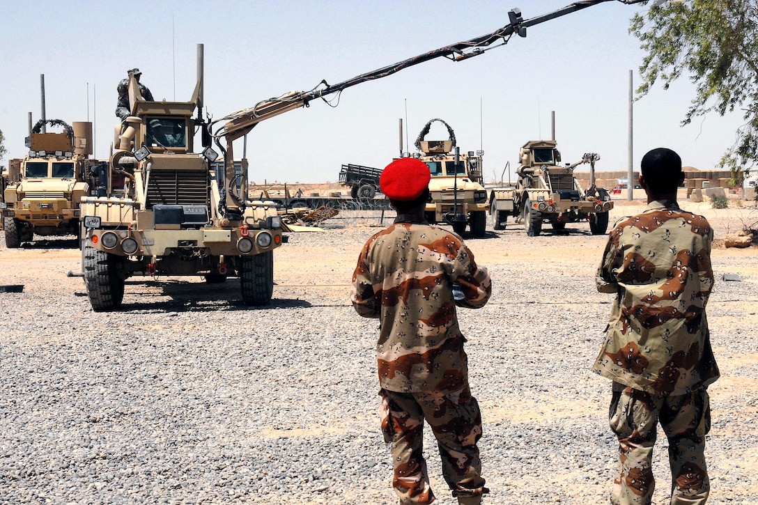 Two Iraqi army soldiers watch as U.S. Army soldiers practice route ...