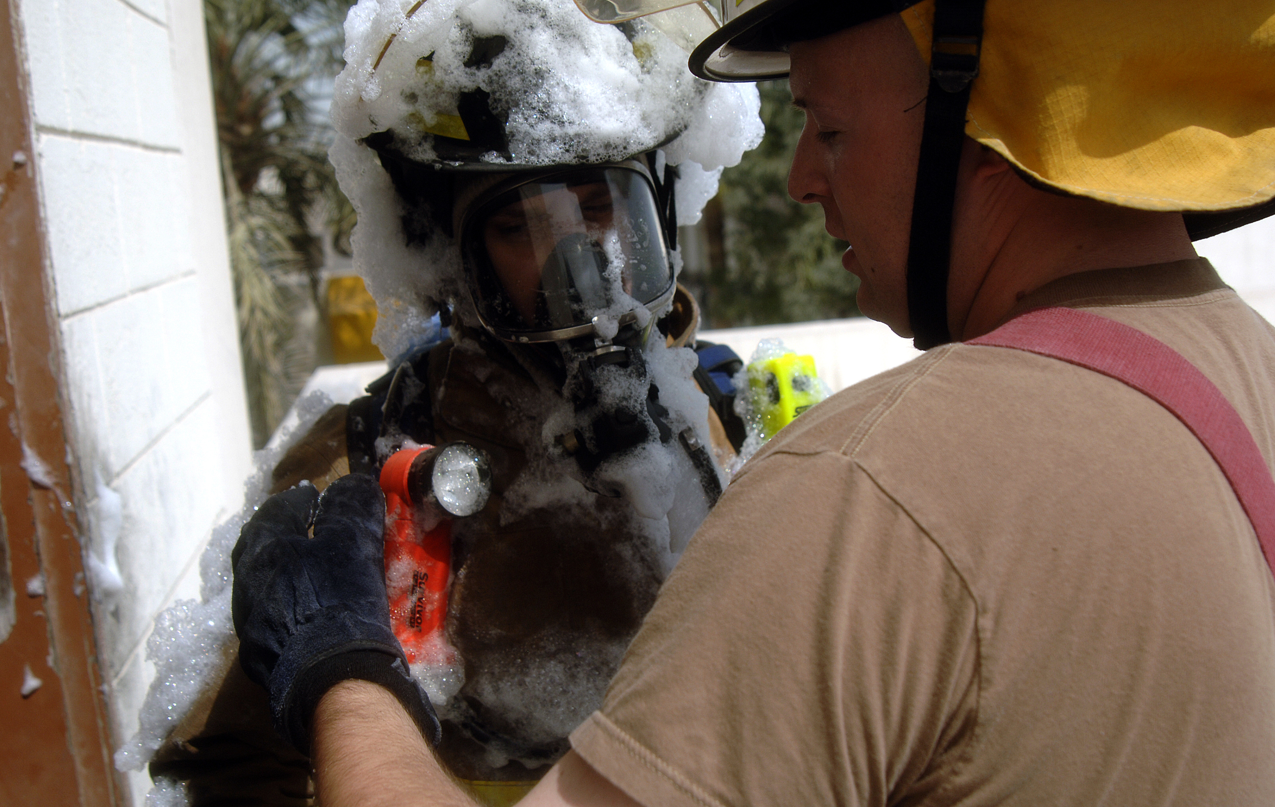 U.S. Navy Petty Officer 1st Class Scott Moore checks the fire-fighting ...