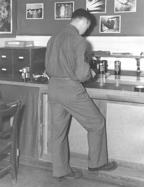 Sergeant examines photographic equipment
