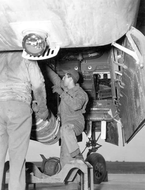 Using hoist to load bombs