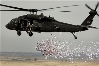 Soldiers drop leaflets over a village near Hawijah.