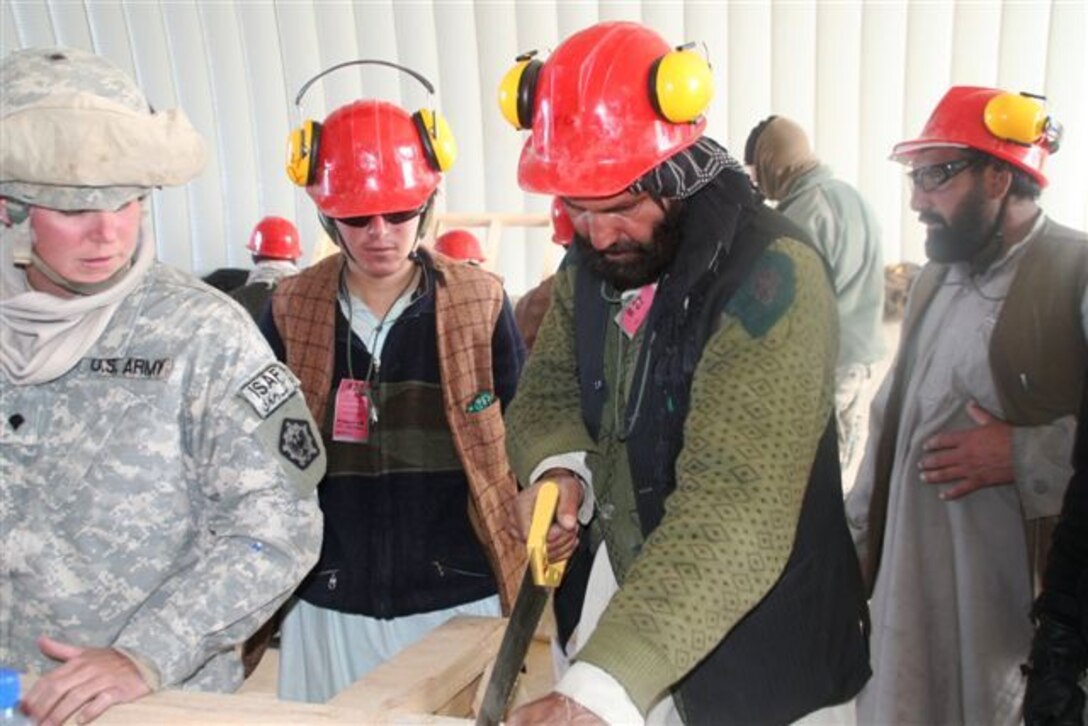 Army Spc. Jennifer Sims teaches 10 Afghan men basic carpentry skills at ...