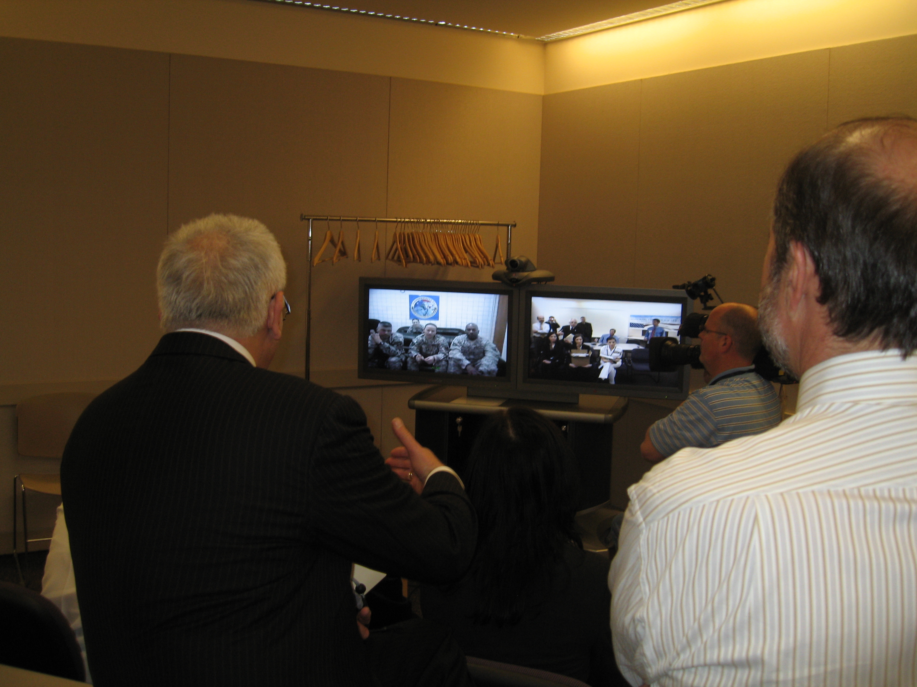 A crowd inside the Chrysler headquarters in Auburn Hills, Mich., talks ...