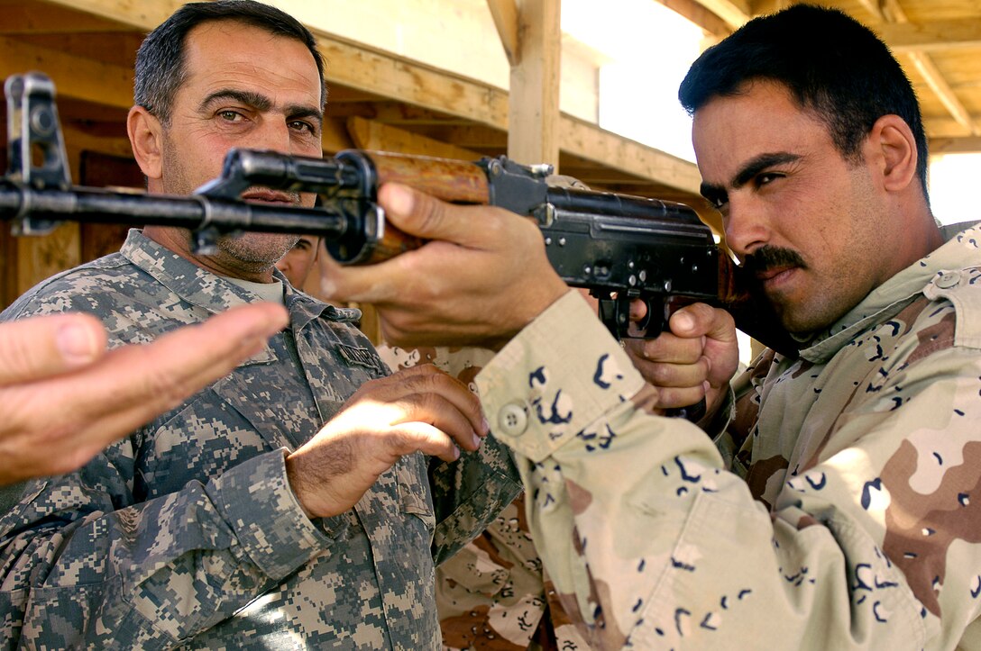 An Iraqi army soldier steadies his weapon and practices his trigger ...
