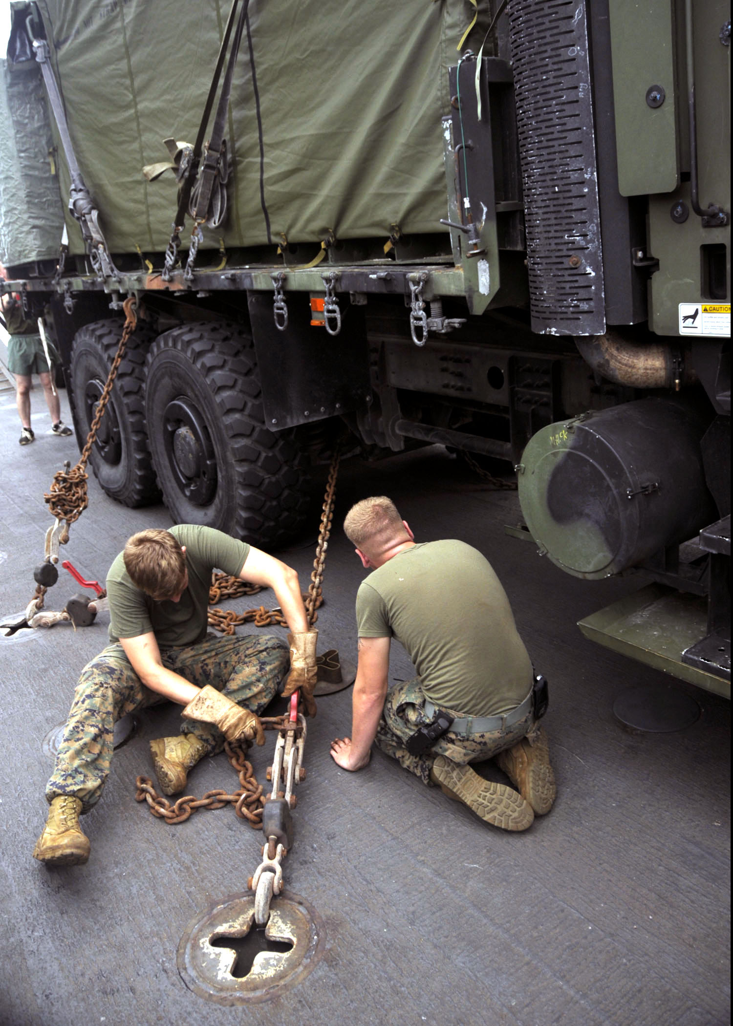 U.S. Marines chain down a tactical water purification system aboard USS ...
