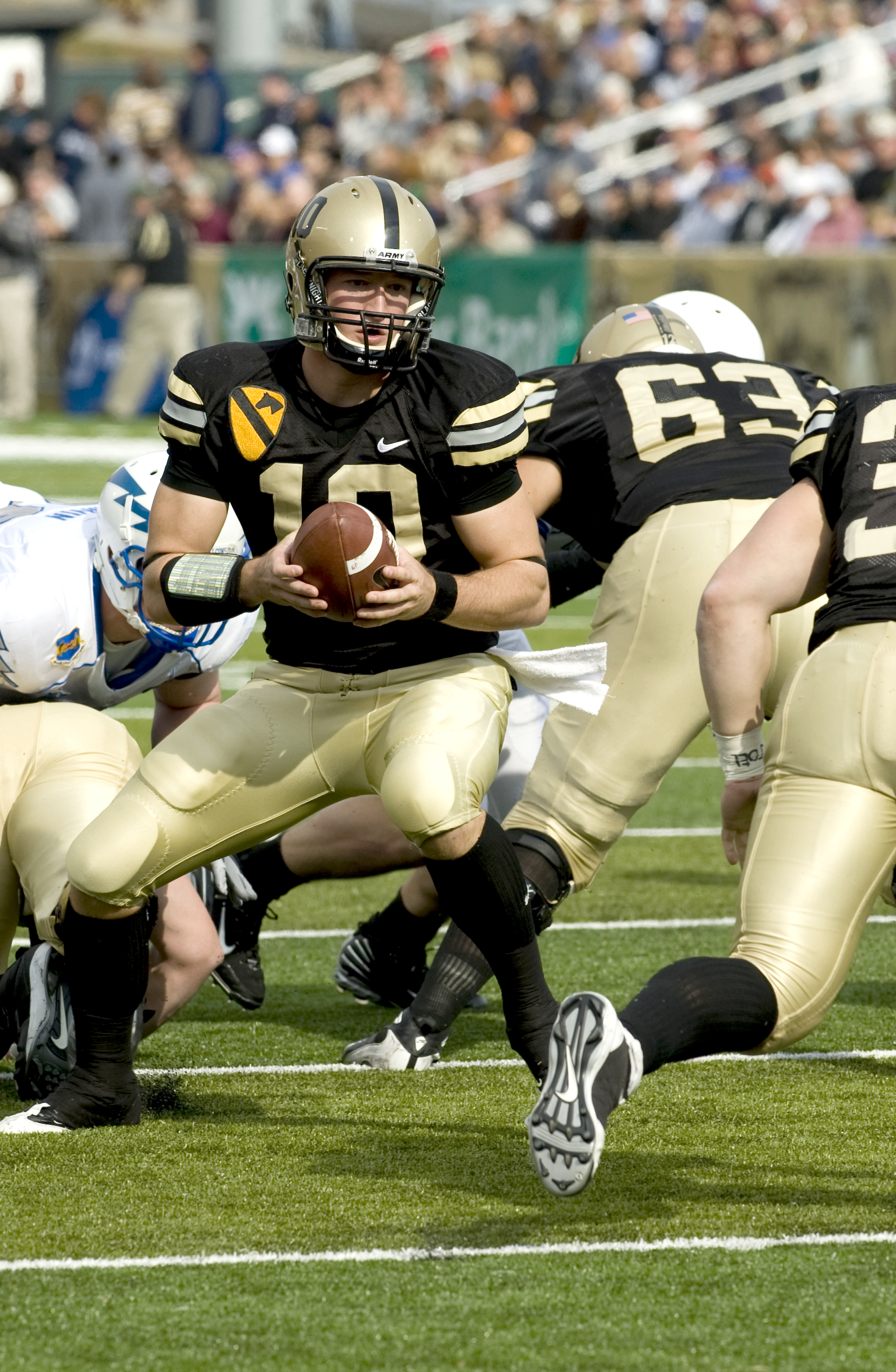 U.S. Military Academy quarterback Chip Bowden hands off the football to ...