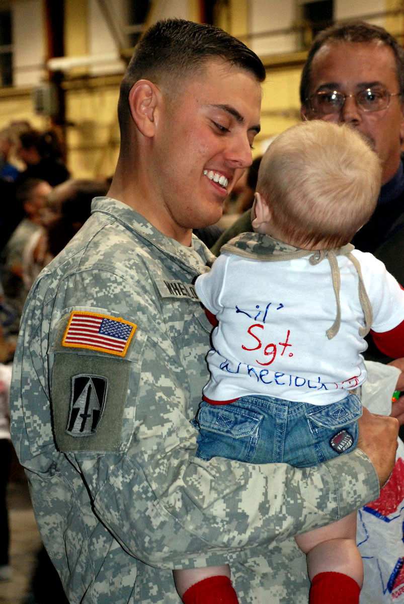 Indiana National Guard Sgt. Michael Wheelock smiles at his son Carsen ...