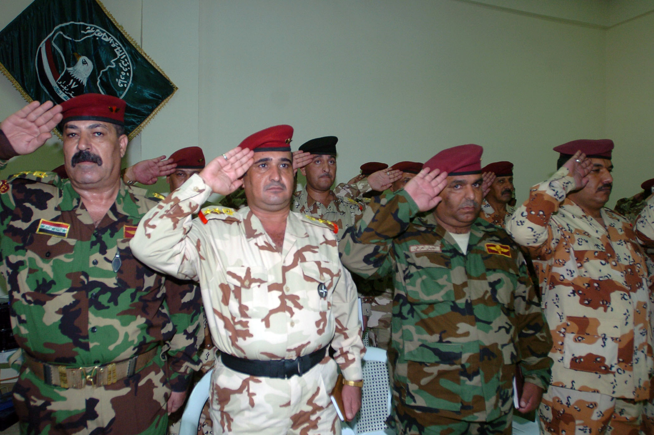 Iraqi soldiers salute during their national anthem at a ceremony ...