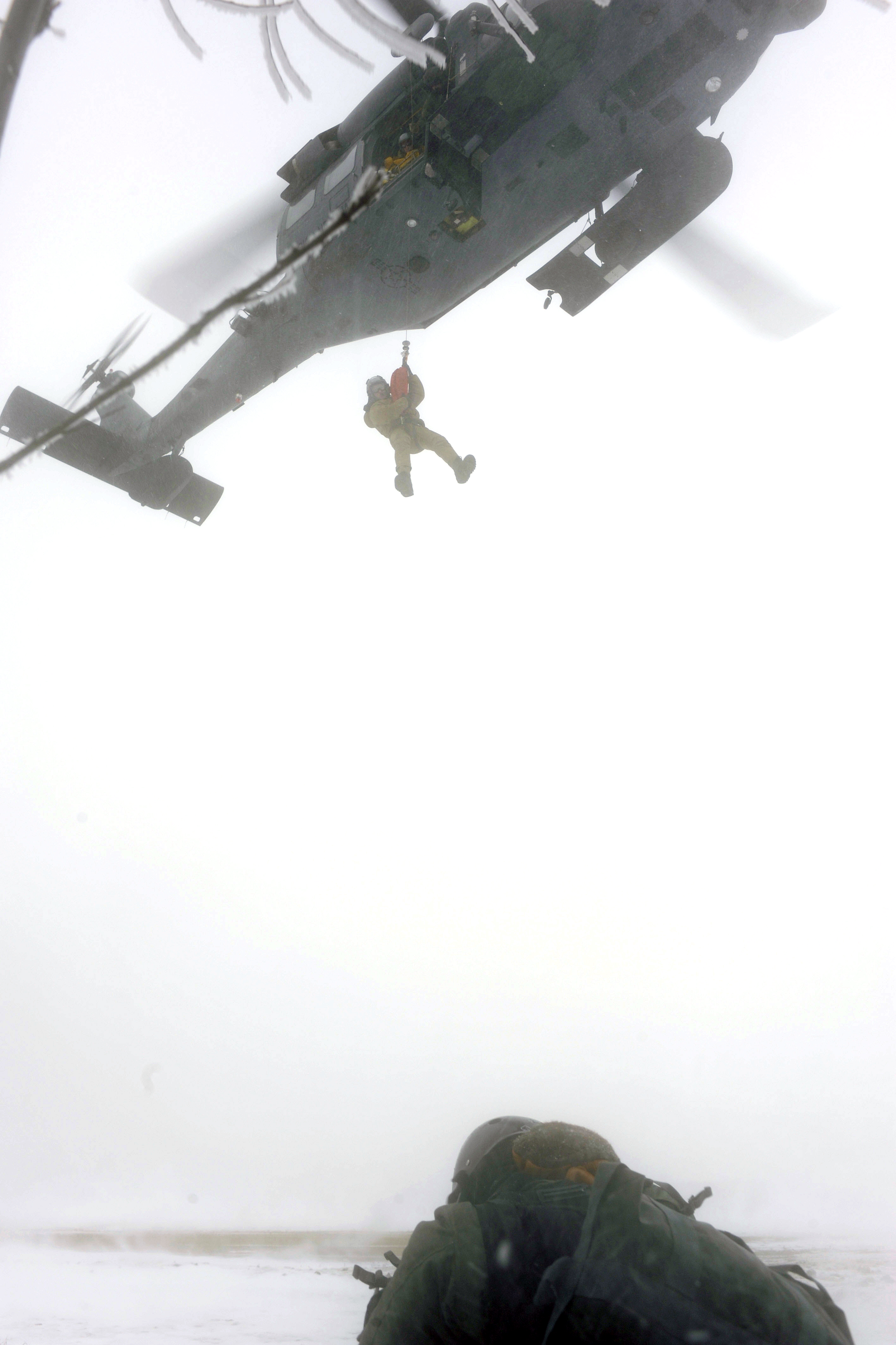 U.S. Air Force Tech. Sgt. Chris Robertson rappels from an HH-60 Pave ...