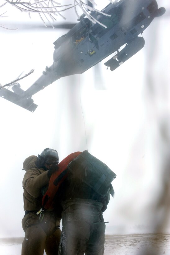 U.S. Air Force Tech. Sgt. Chris Robertson helps 1st Lt. Matthew Feeman ...