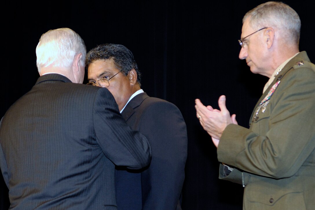 Defense Secretary Robert M. Gates, left, presents John K. Russell ...