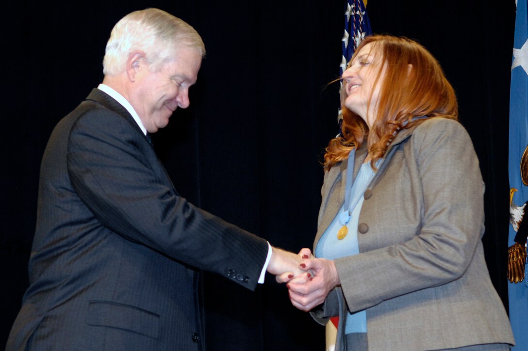 Defense Secretary Robert M. Gates, left, congratulates Barbara Estock ...