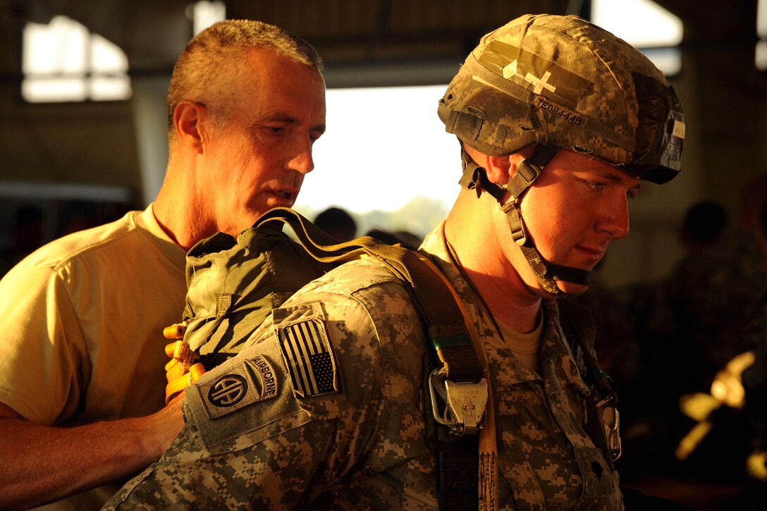 U.S. Army Master Sgt. Jeffrey Tyler checks Spc. Edwin Tyren's gear and ...