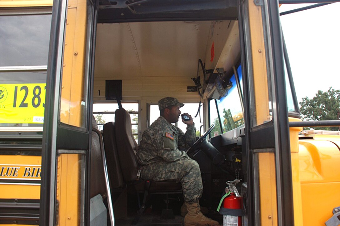 A member of the Louisiana National Guard prepares to drive a school bus ...