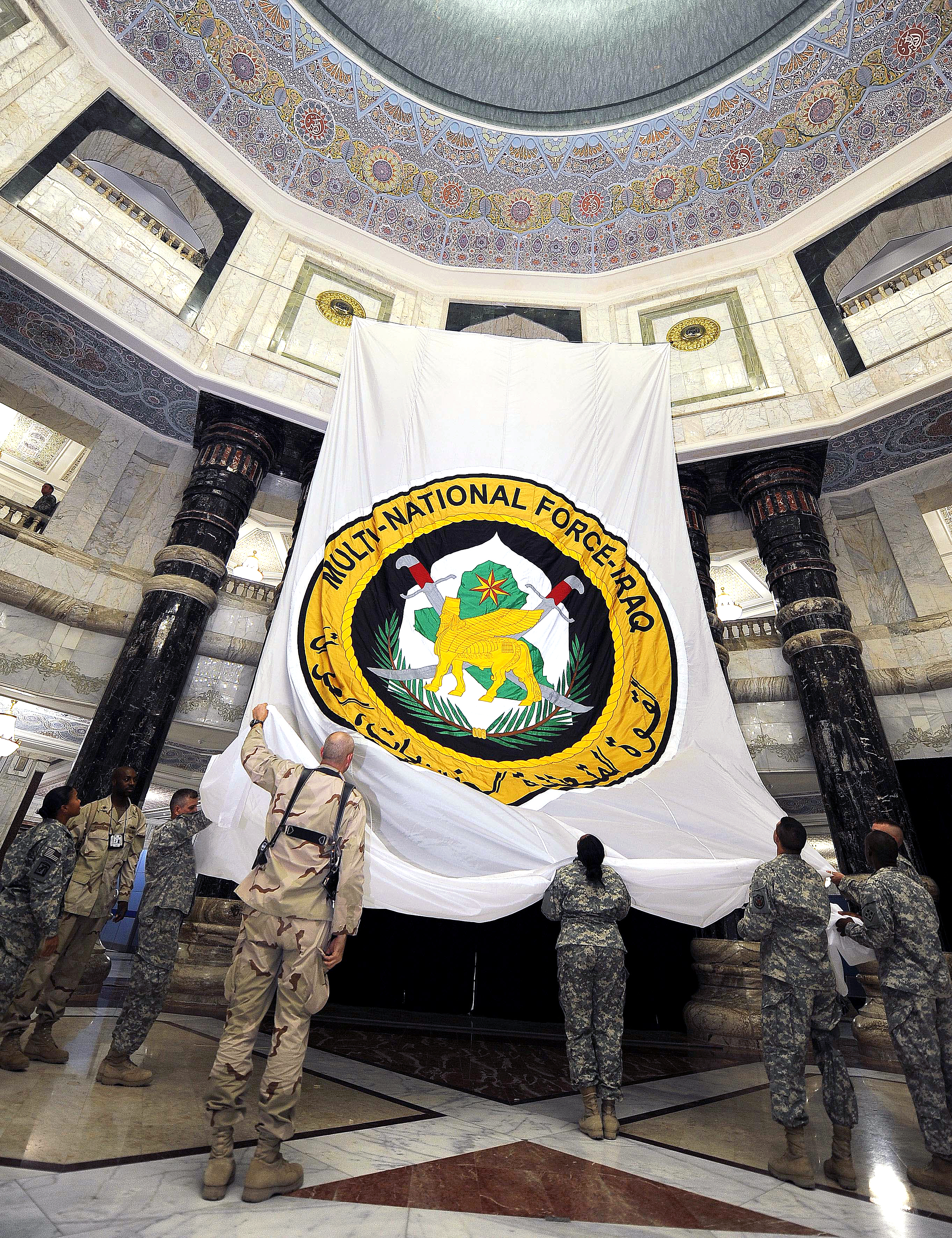 Military members of Multinational Force Iraq straighten out an enormous ...