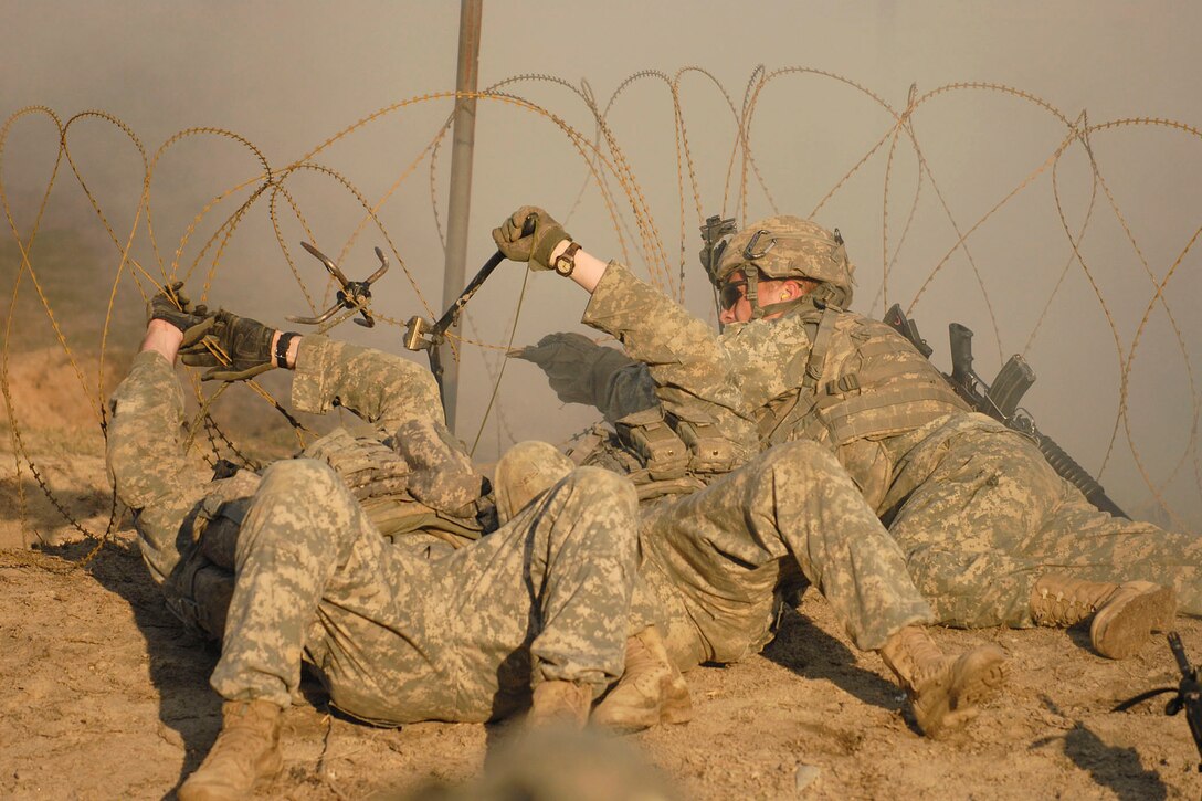U.S. Army soldiers from the "breaching team" manage to cut through ...