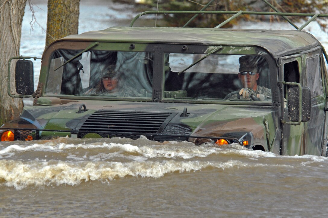 U.S. Army Staff Sgt. William Griffin, right, assigned to the 136th ...