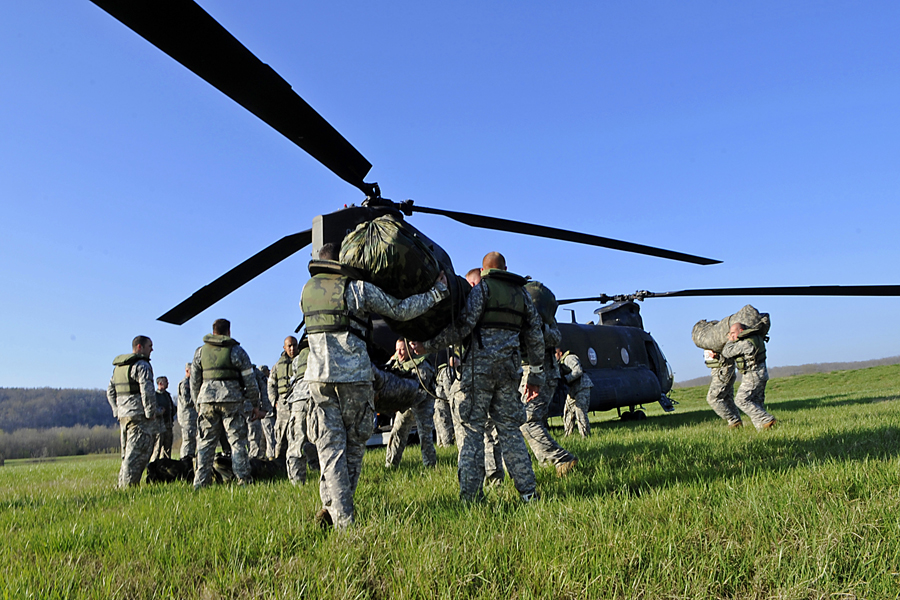 Soldiers receive final instructions before boarding the aircraft in the ...