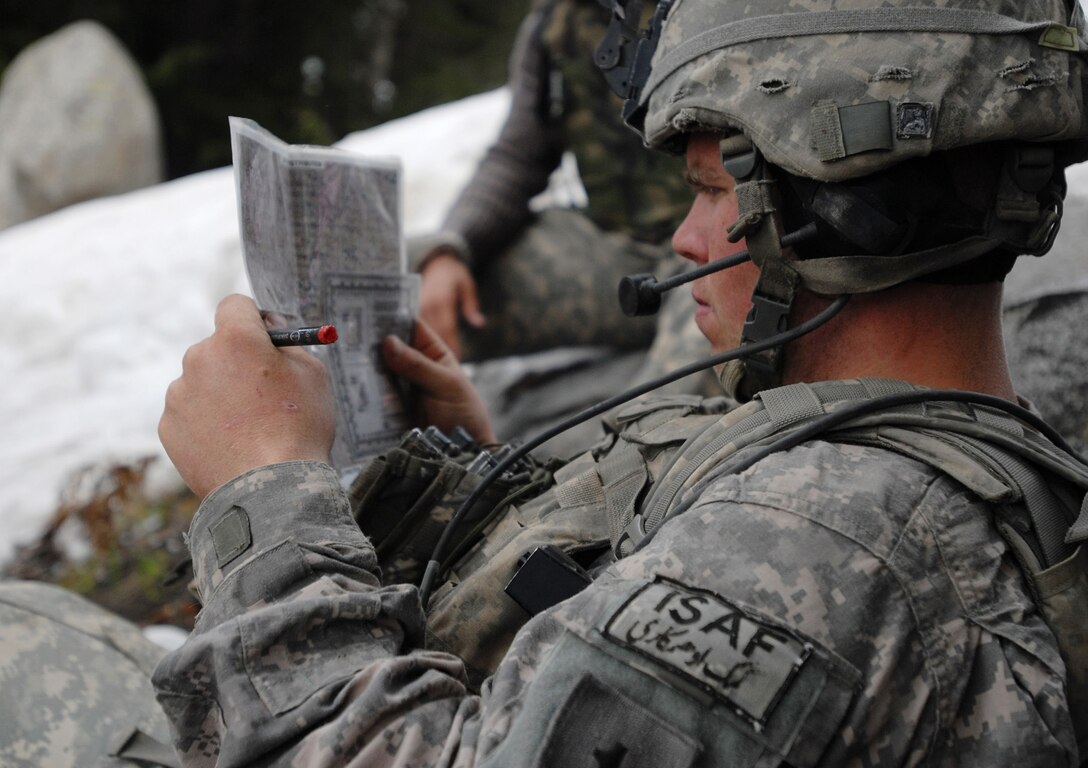 U.S. Army Pfc. Matthew Boyd checks the distance to the next objective ...