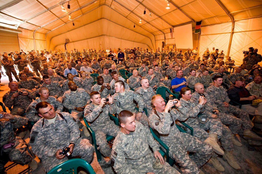 Troops take photos as they listen to country music singer Toby Keith ...
