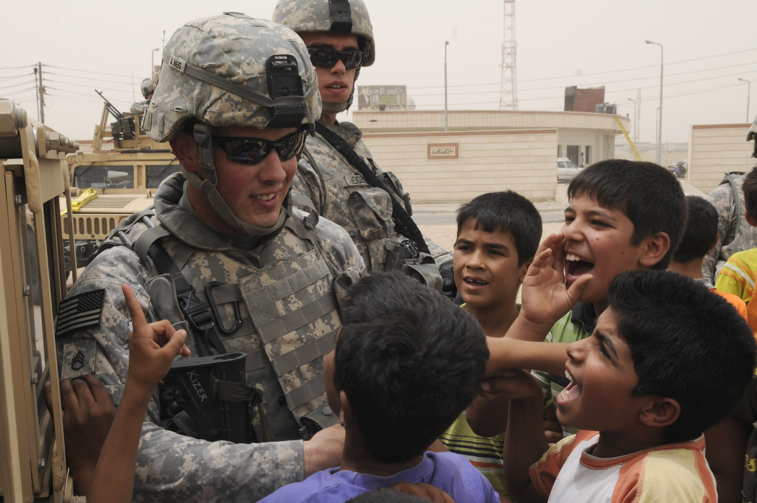 U.S. Army Staff Sgt. Victor Kizer passes out toys to local Iraqi ...