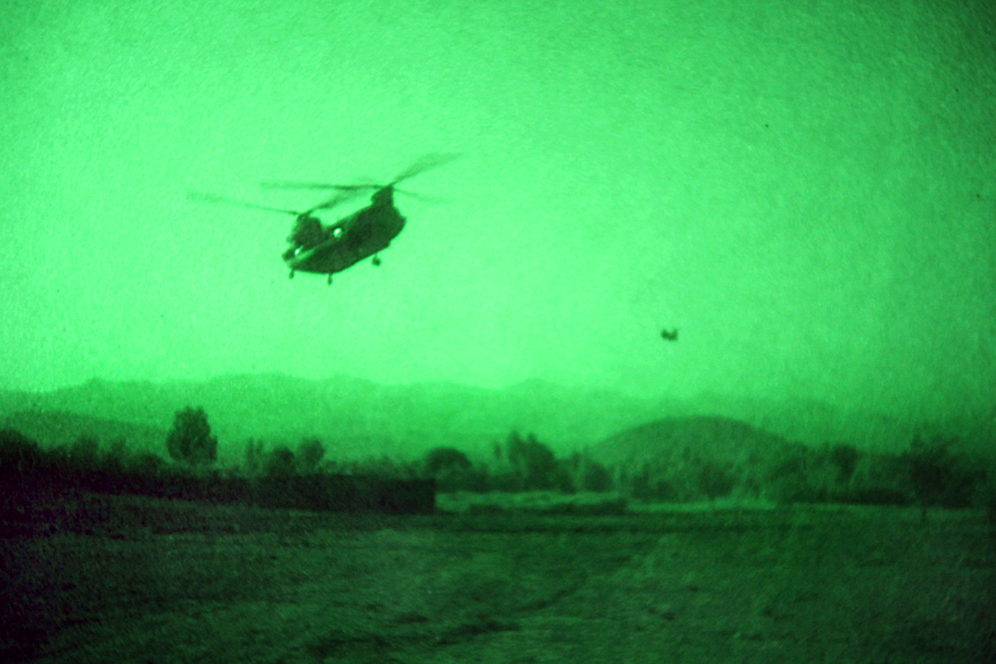 As seen through a night-vision device, U.S. Army CH-47 Chinook ...