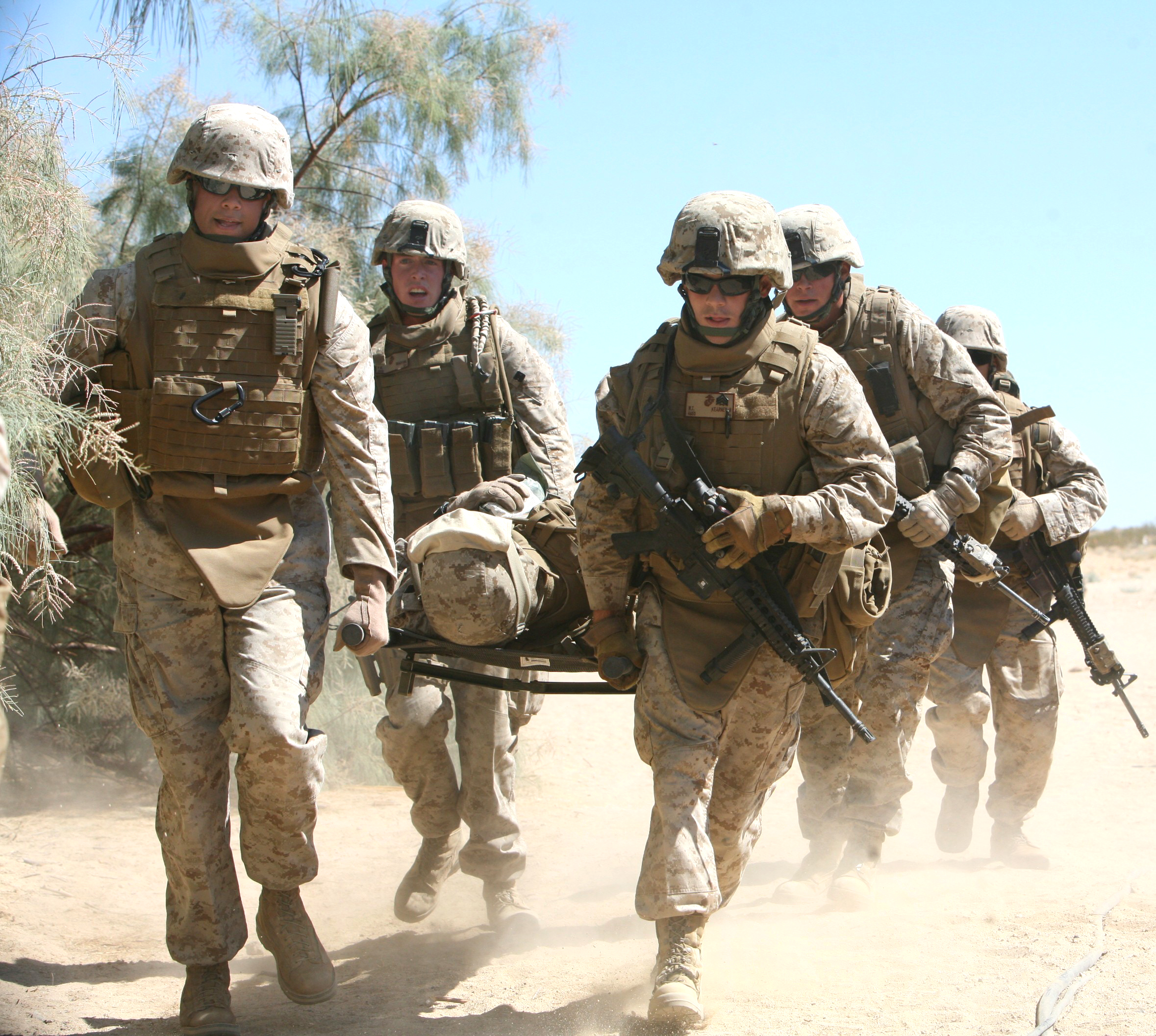 U.S. Marines carry a comrade wounded in a simulated indirect fire ...