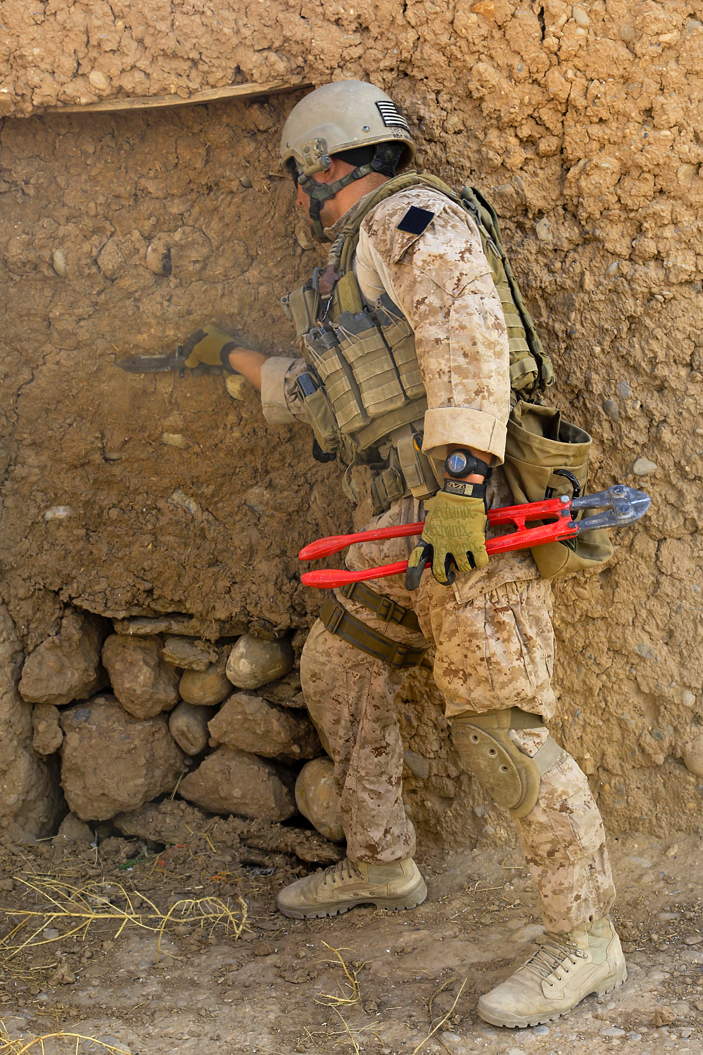 U.S. Marine Corps Sgt. John Sheets examines a compound for improvised ...