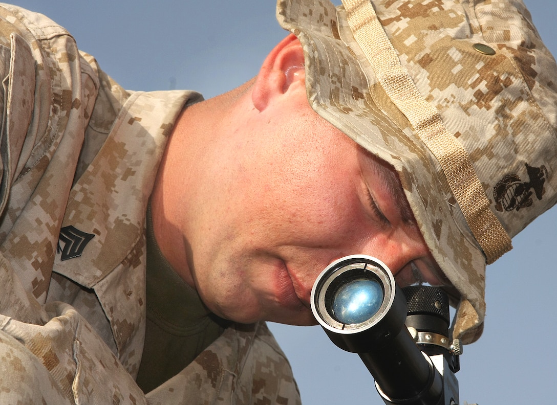 U.S. Marine Corps Sgt. Andrew C. Wedde looks through a boresight ...