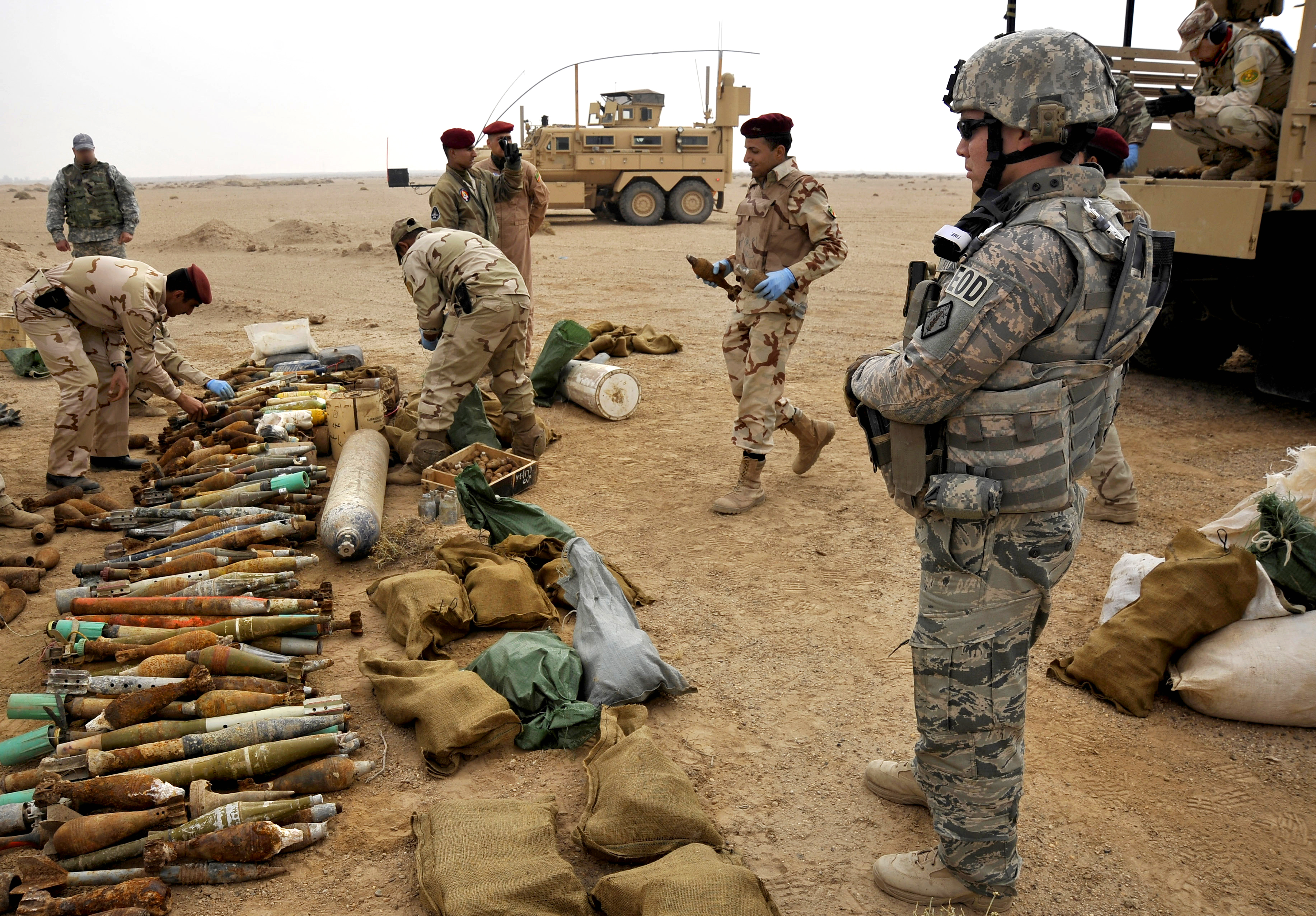 U.S. Air Force Tech. Sgt. David Fields supervises as Iraqi soldiers place enemy explosives in a ...
